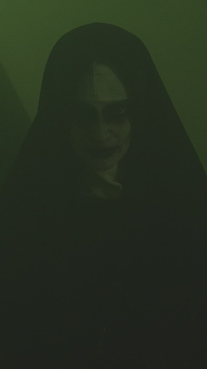 Portrait of a ghostly nun in a dark place - Free Stock Video