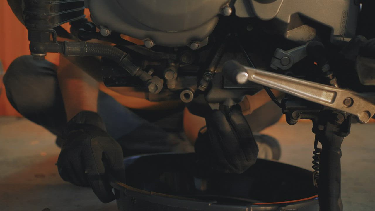 Mechanic repairing a motorcycle engine - Free Stock Video