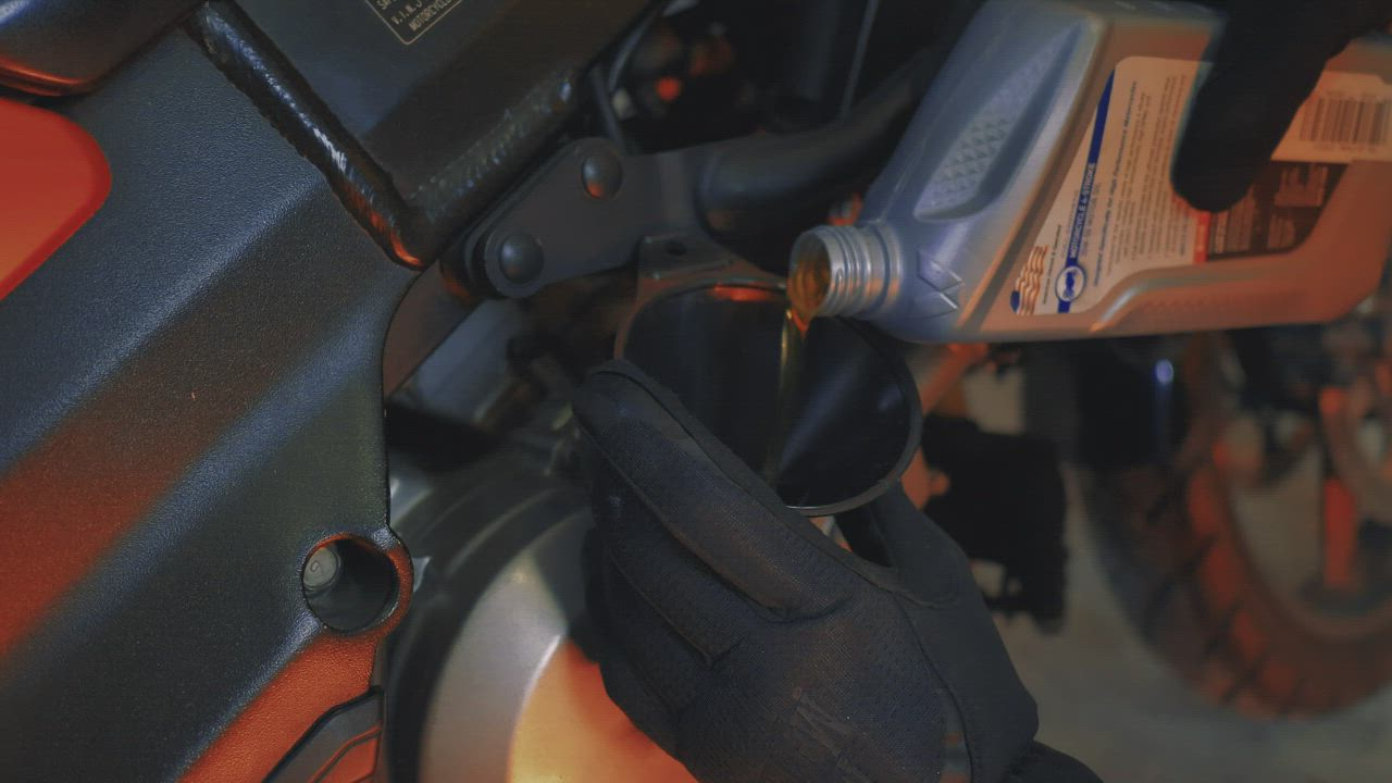 Mechanic changing the oil of a motorcycle - Free Stock Video