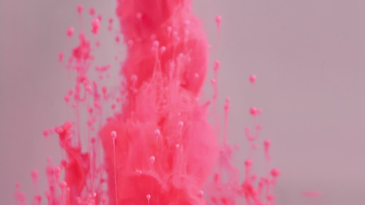 Dynamic movement of pink ink clouds in water - Free Stock Video