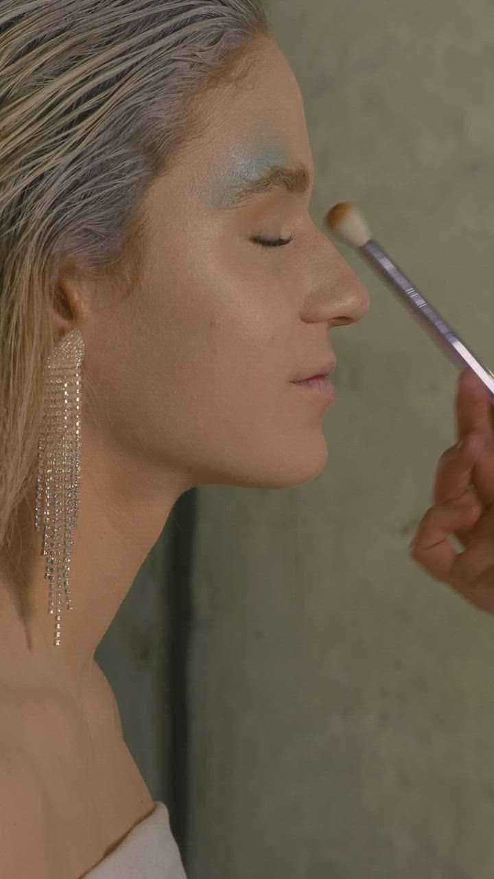 Profile shot of model with her makeup artist - Free Stock Video