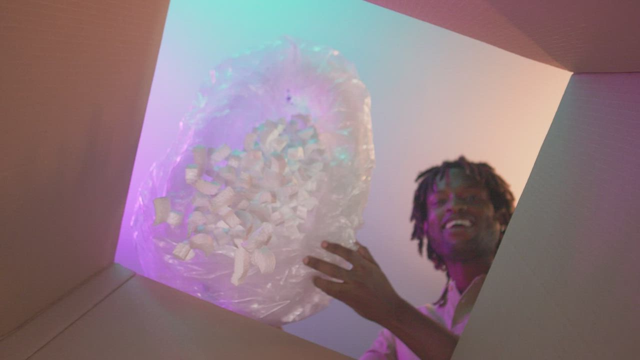 Young man filling a stuffing box for packing - Free Stock Video