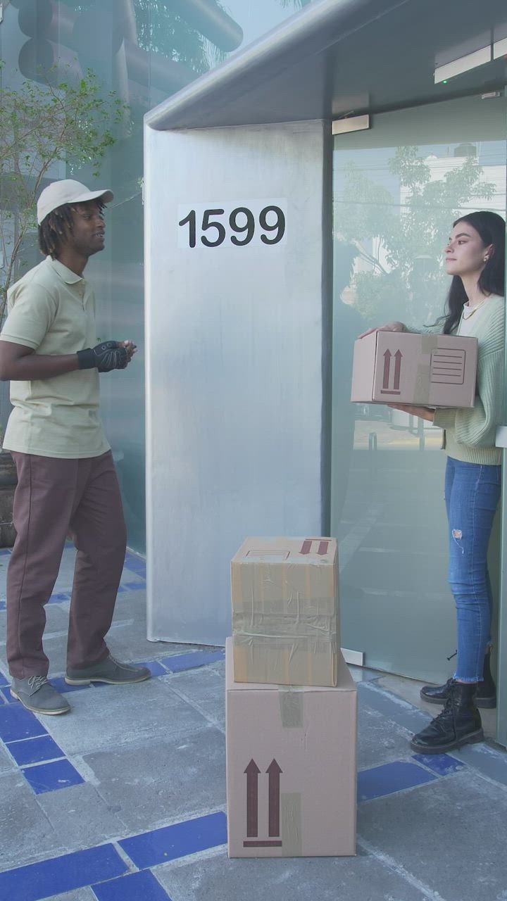 Postman delivering a package to a girl - Free Stock Video