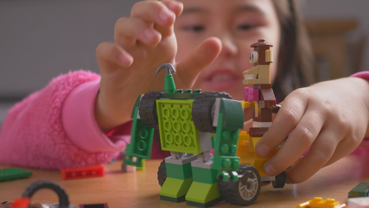 Little girl playing with lego toys - Free Stock Video