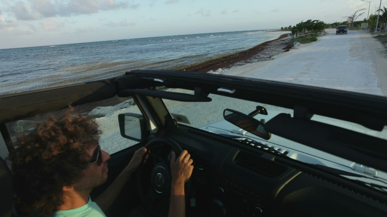 Driving in a beach town near the seashore - Free Stock Video