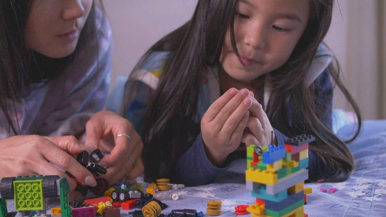 Mother and daughter playing together with legos - Free Stock Video