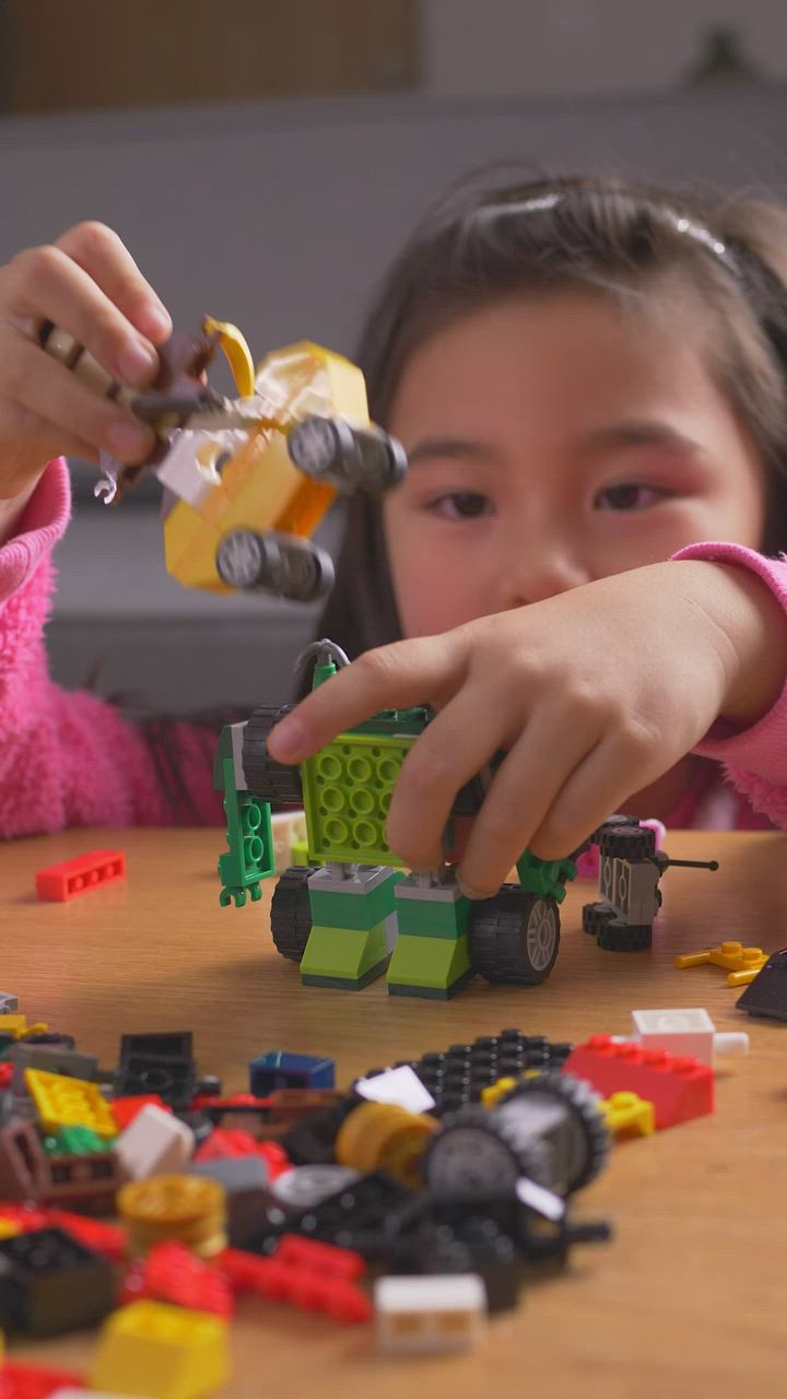 Little girl playing with her legos - Free Stock Video