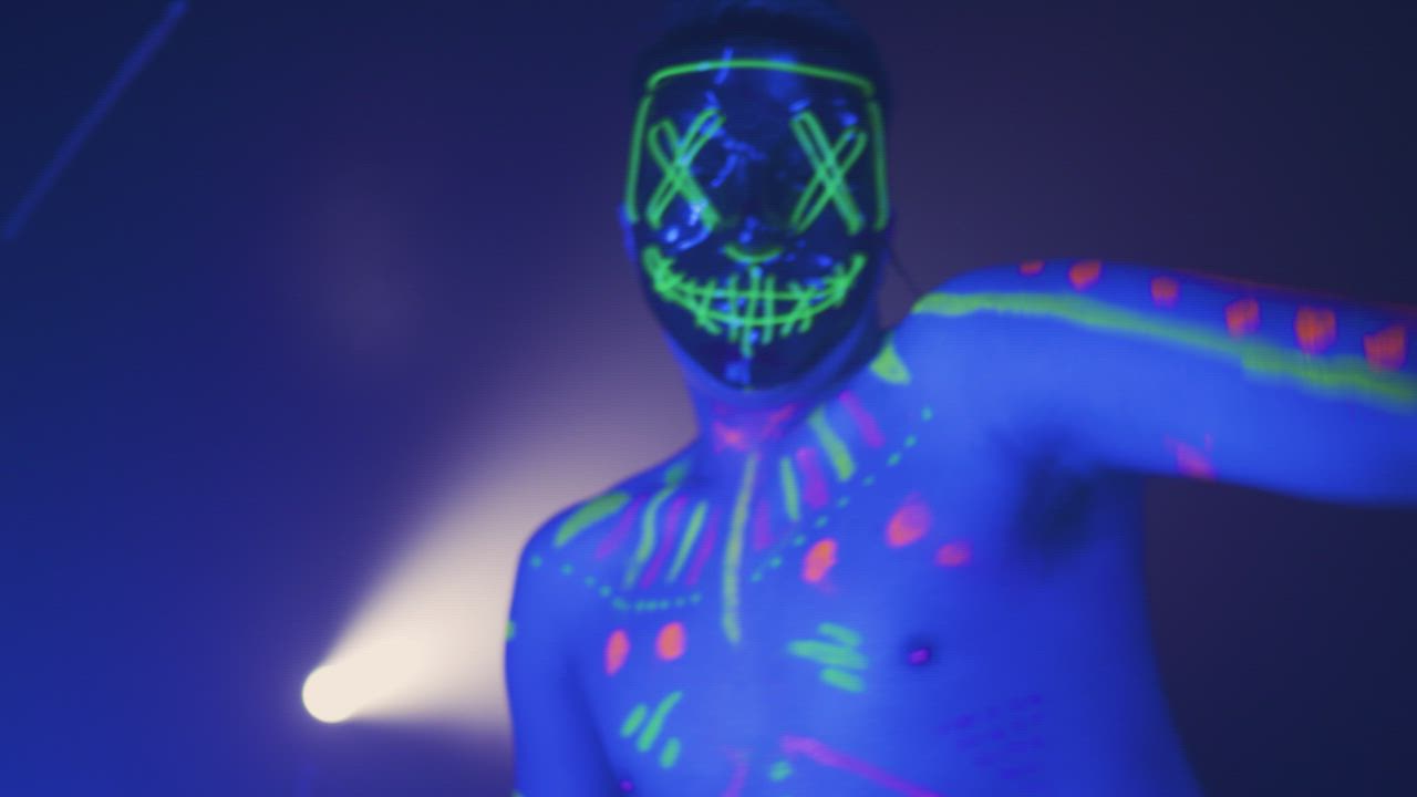 Portrait of an urban dancer wearing a neon mask dancing - Free Stock Video