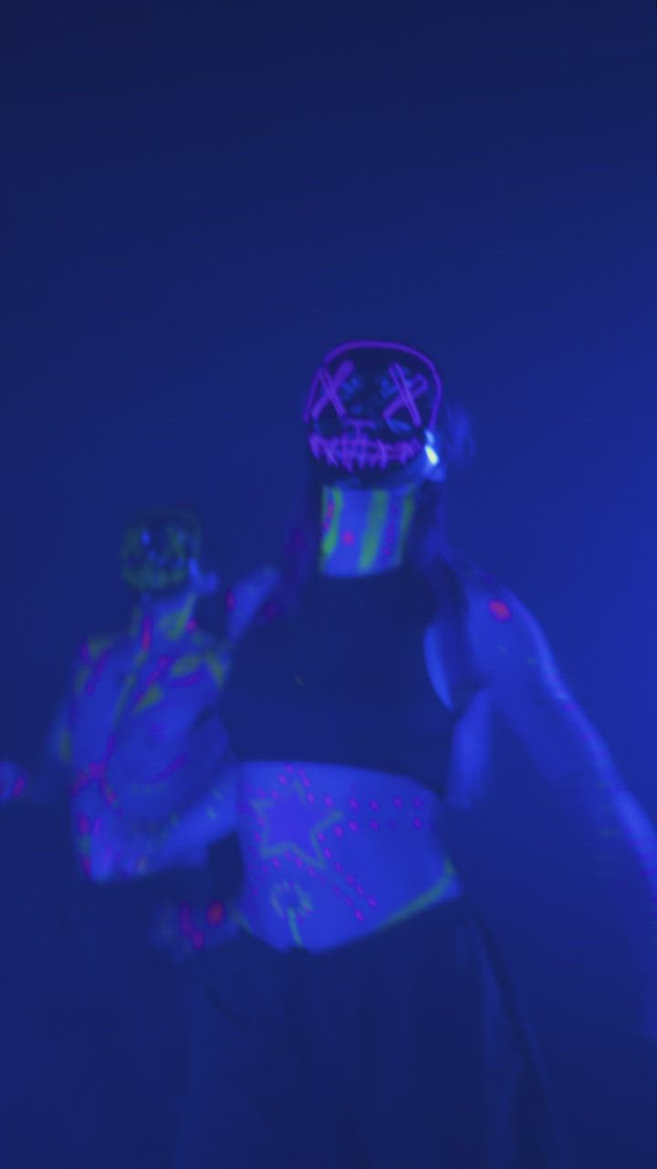 A boy and a girl dancing with a mask - Free Stock Video