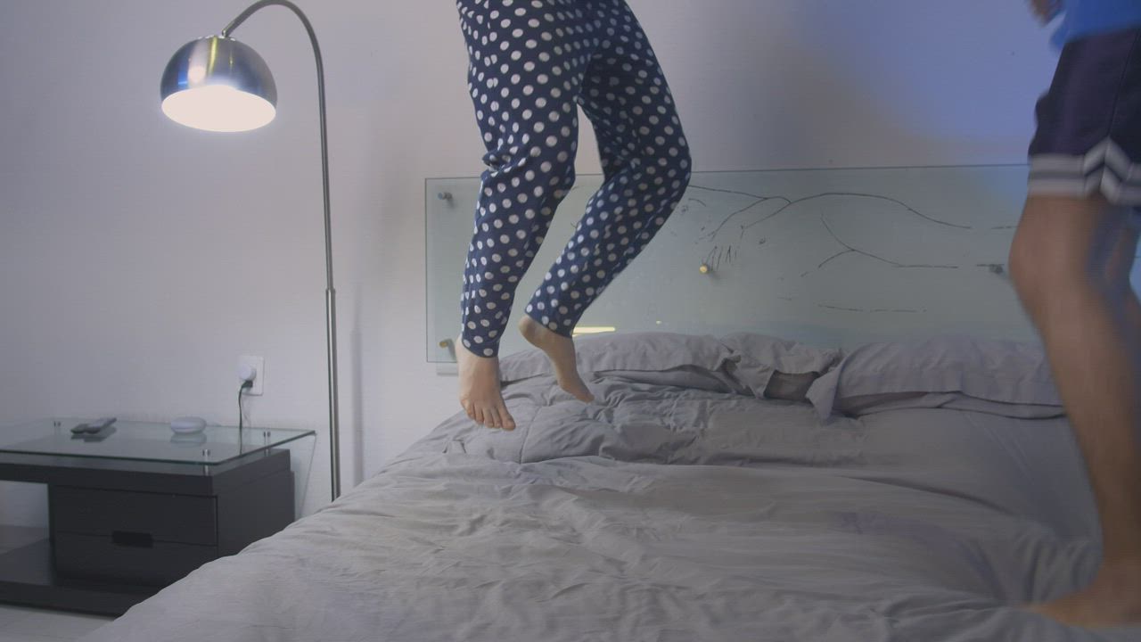 Happily couple jumping on a bed - Free Stock Video