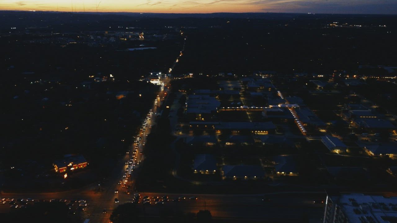 Flying over a city at dusk - Free Stock Video