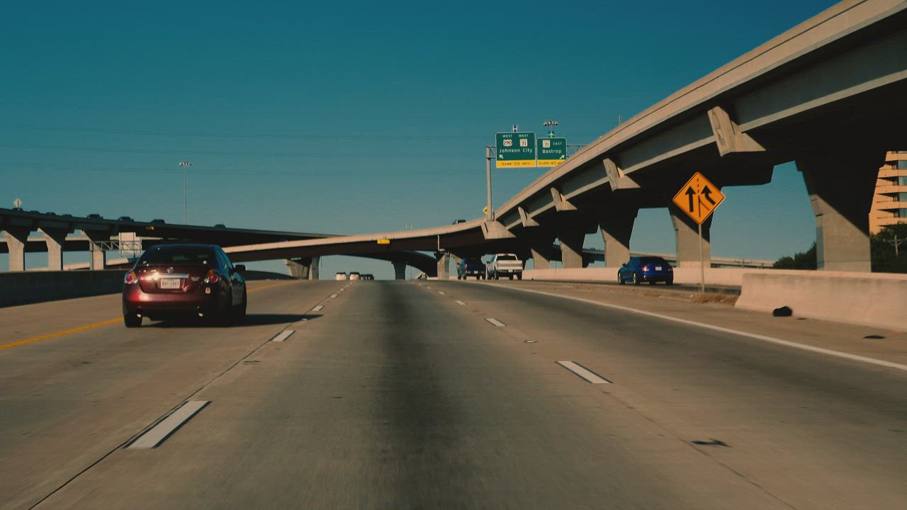 Traveling down a highway on a sunny day - Free Stock Video