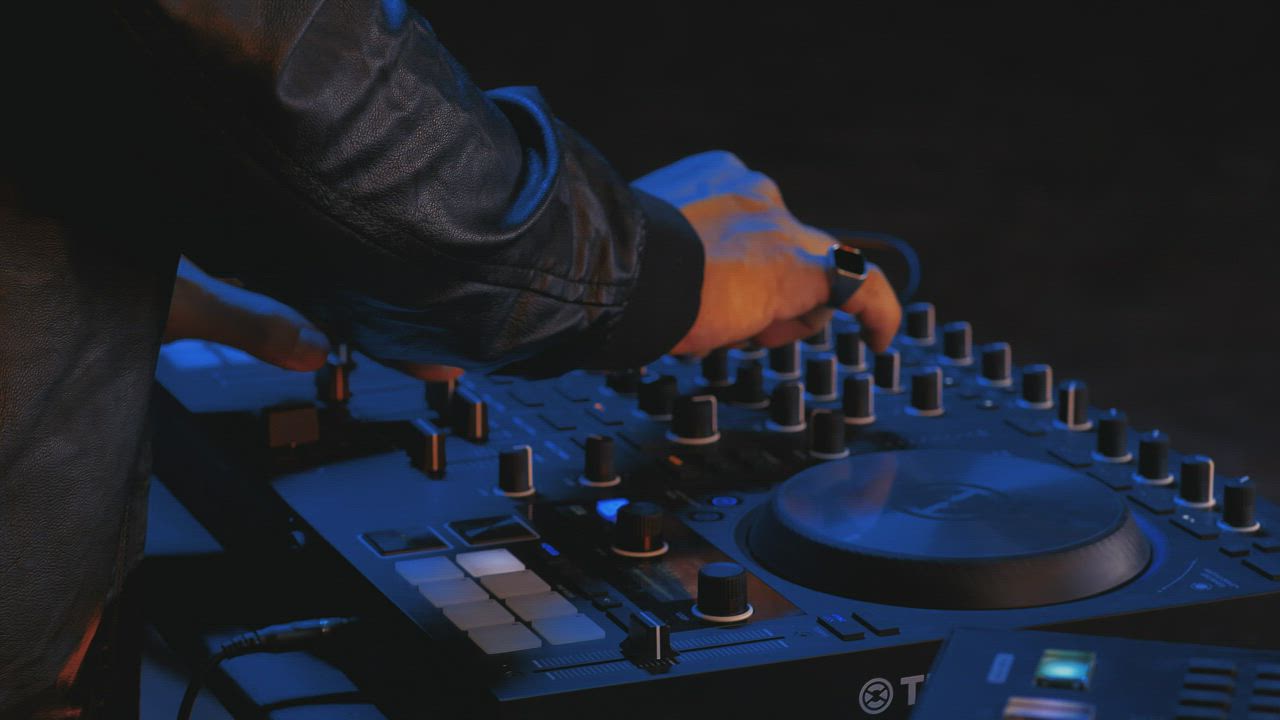 Hands of a DJ turning knobs on his equipment - Free Stock Video
