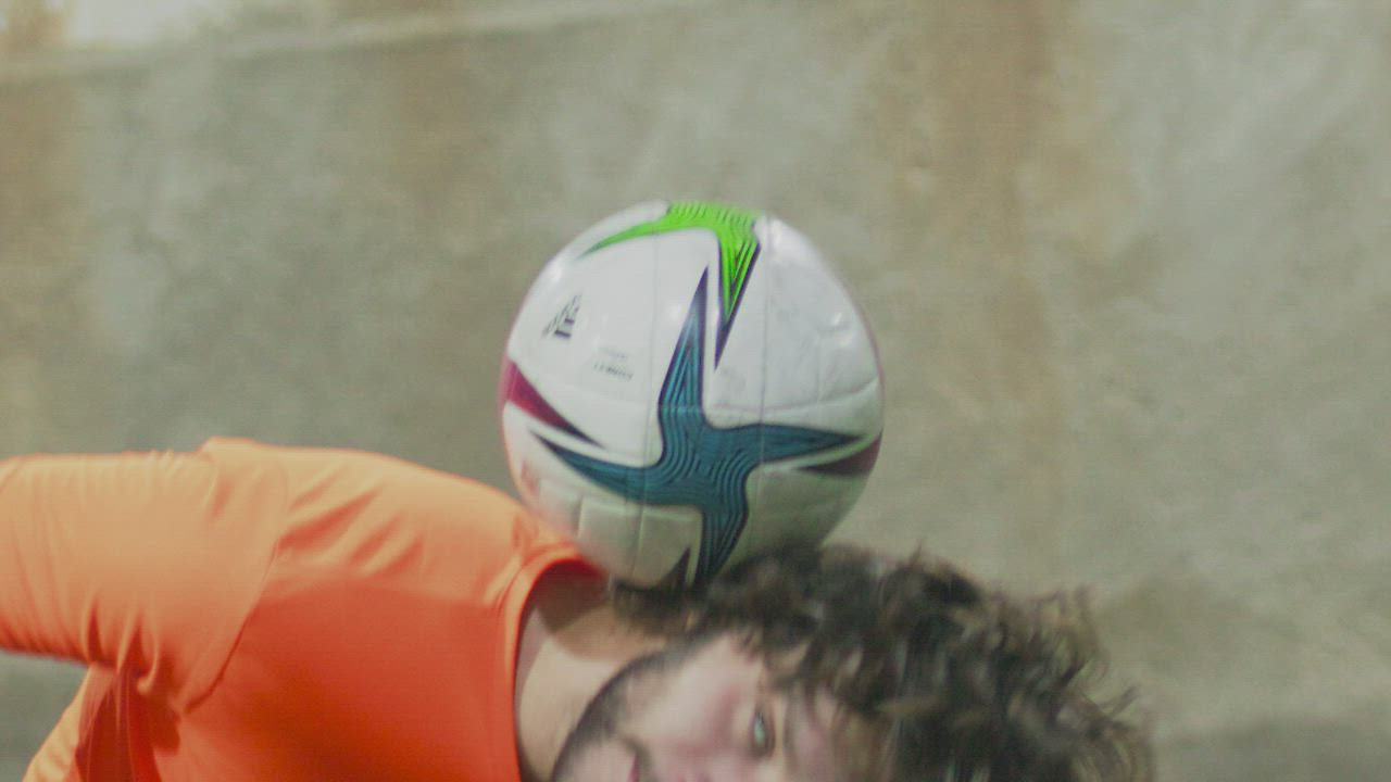 Soccer player juggling a ball with his head - Free Stock Video