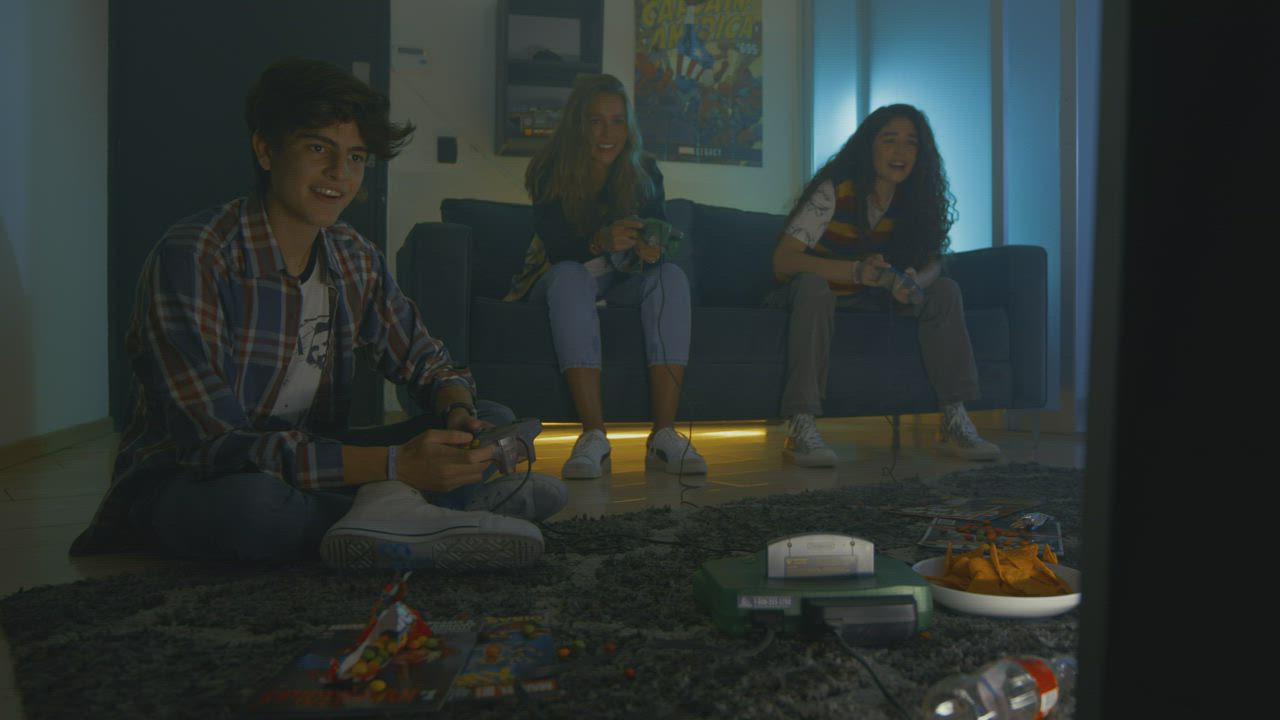 Three young friends playing video games - Free Stock Video