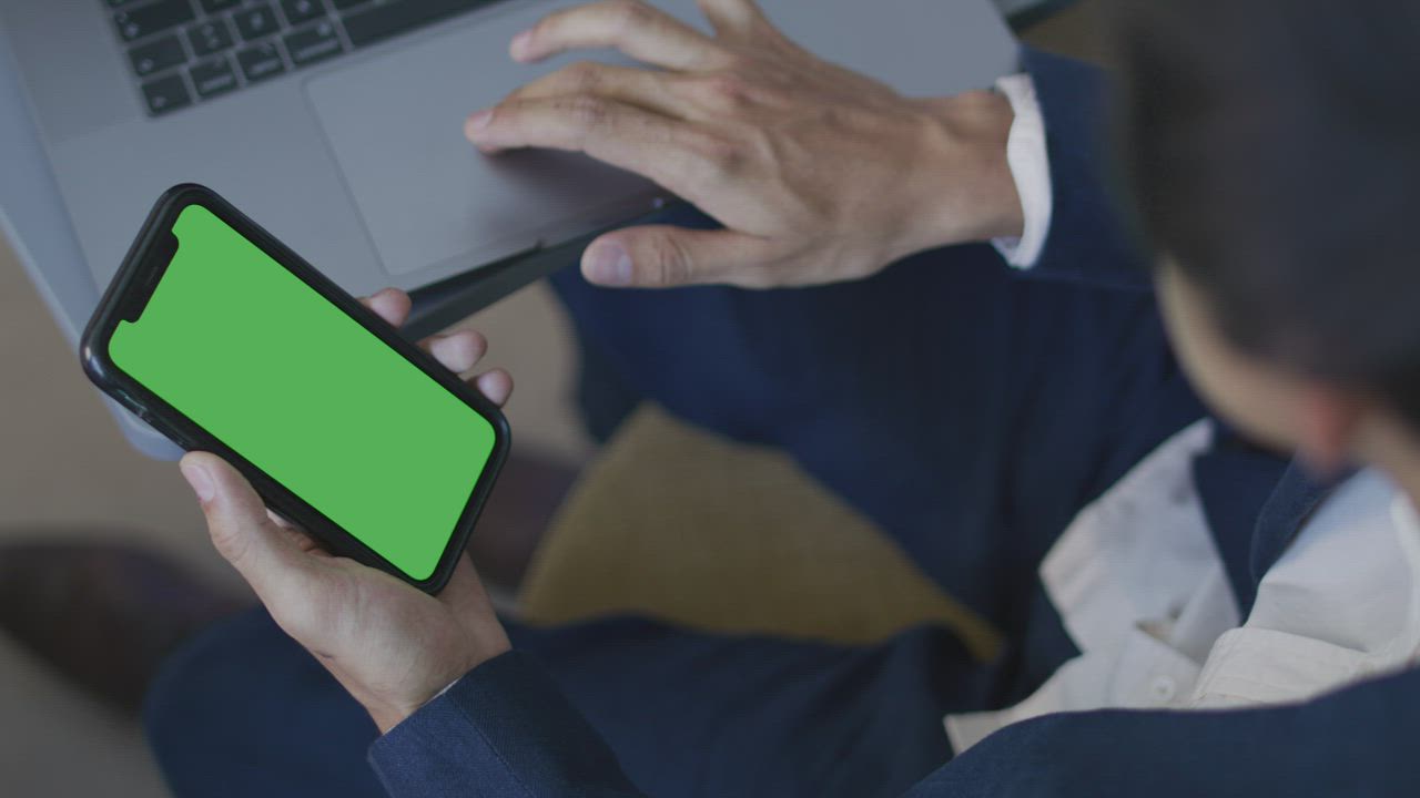 Man using his computer and cell phone - Free Stock Video