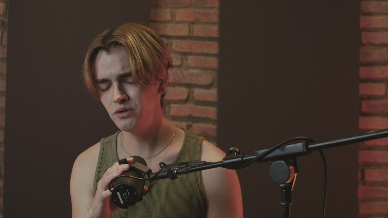 Singer recording vocals in a studio booth - Free Stock Video