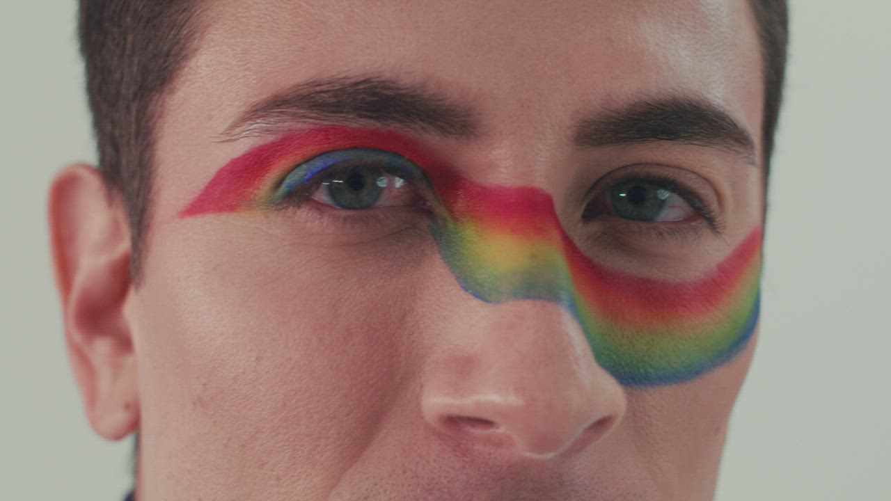 Gaze of an LGBT man with rainbow makeup - Free Stock Video