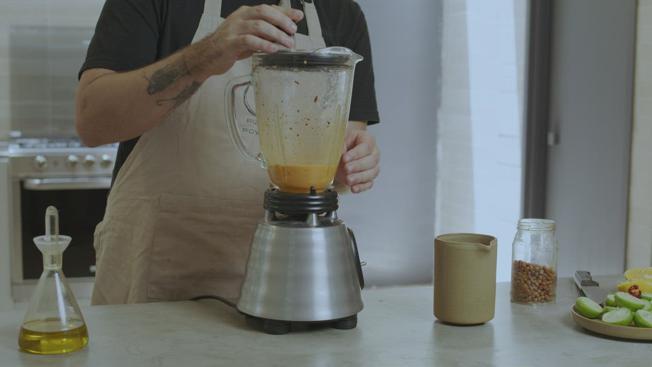 Chef blending a mixture for a dish - Free Stock Video