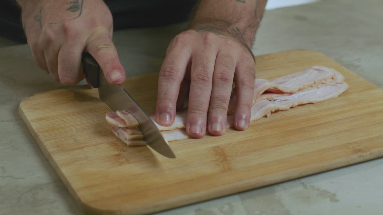 Chef chopping bacon on a board - Free Stock Video