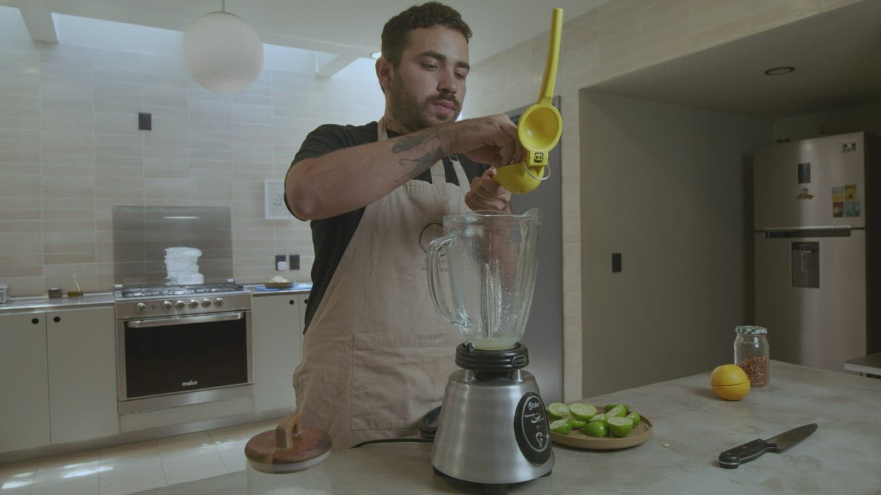 Cook adding ingredients in a blender - Free Stock Video