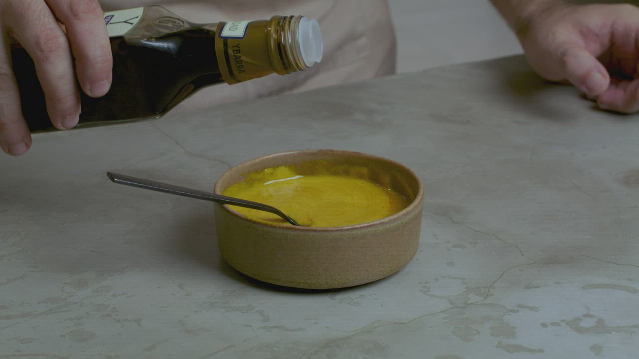 Chef preparing a mixture in a small container - Free Stock Video