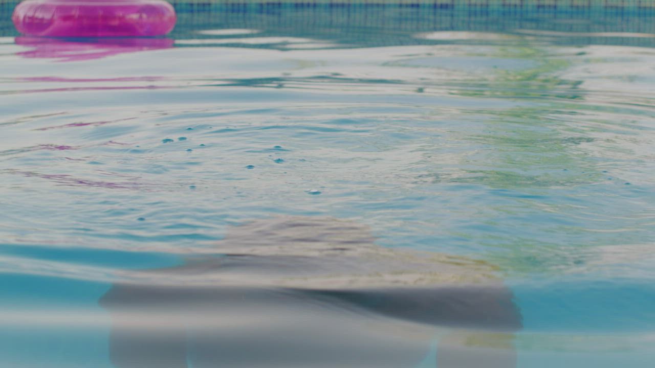 Man getting out of the water in a pool - Free Stock Video