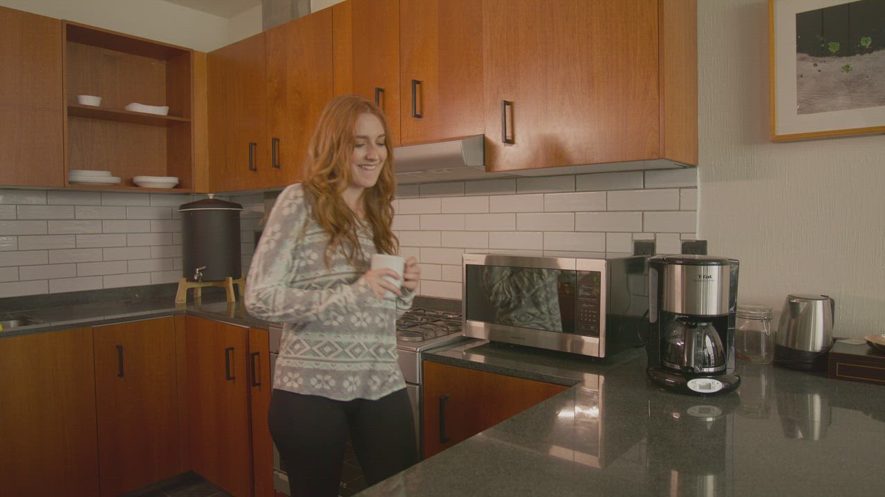 Young woman drinking coffee while dancing - Free Stock Video