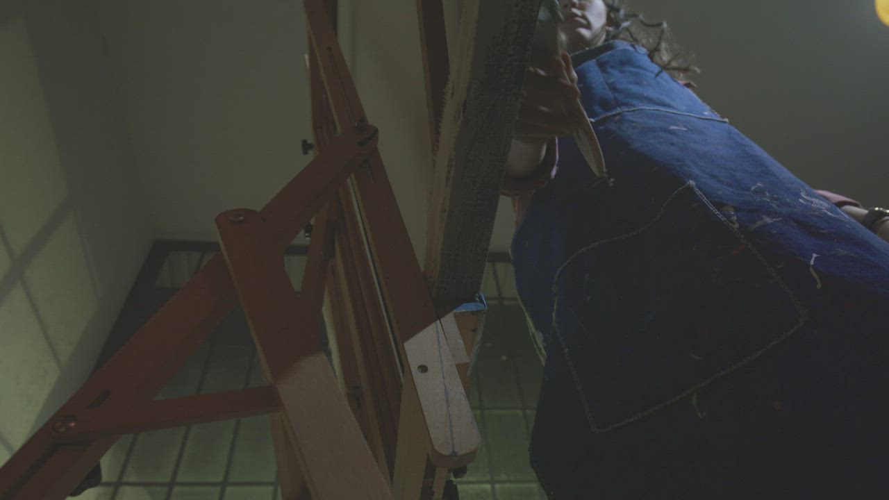 Artist working on a painting shot from below - Free Stock Video