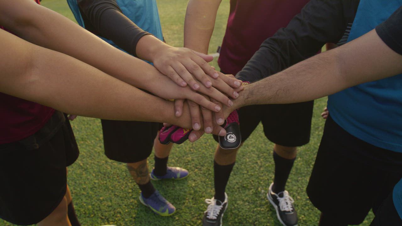 Hands of a soccer team making a cheer - Free Stock Video