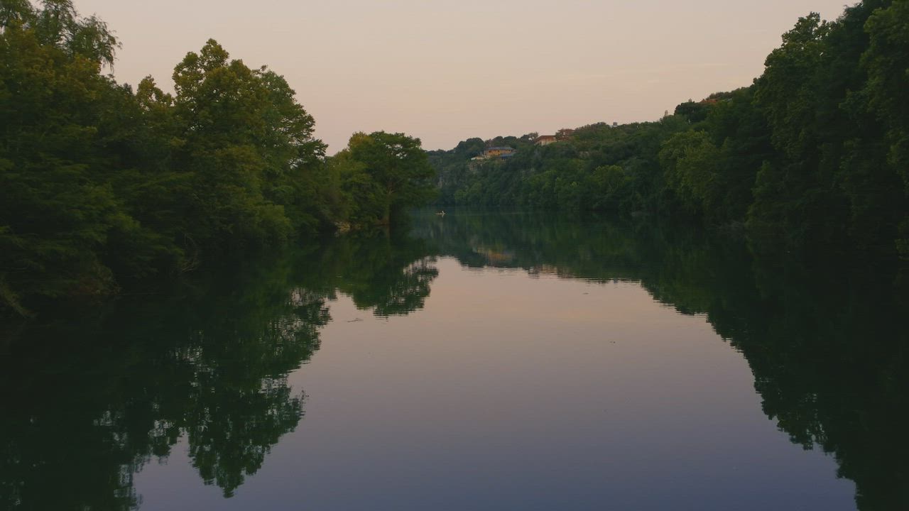 Flying low over a large river in nature - Free Stock Video