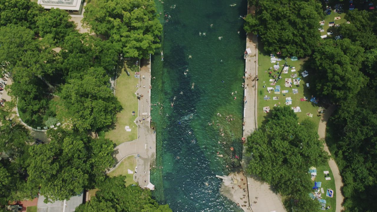 Aerial view of a river with people in and around it - Free Stock Video