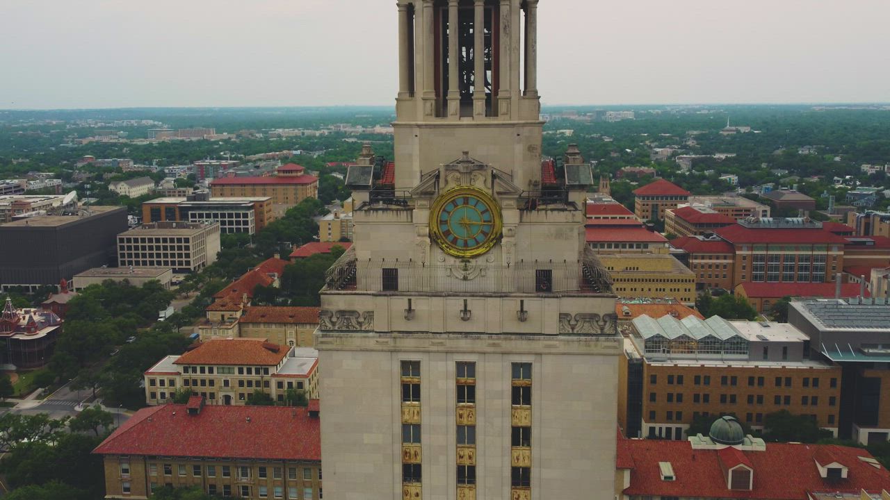 Aerial shot of a tower with a clock in a city - Free Stock Video