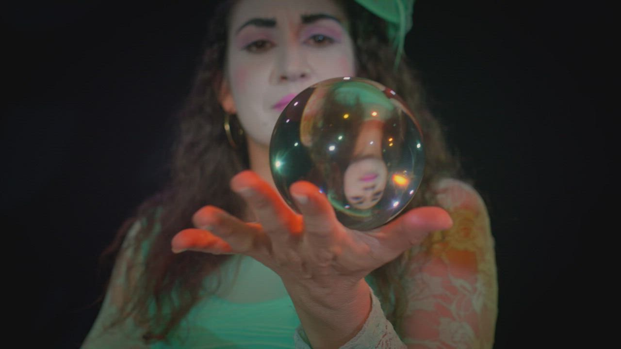 Talented woman doing tricks with a crystal sphere - Free Stock Video