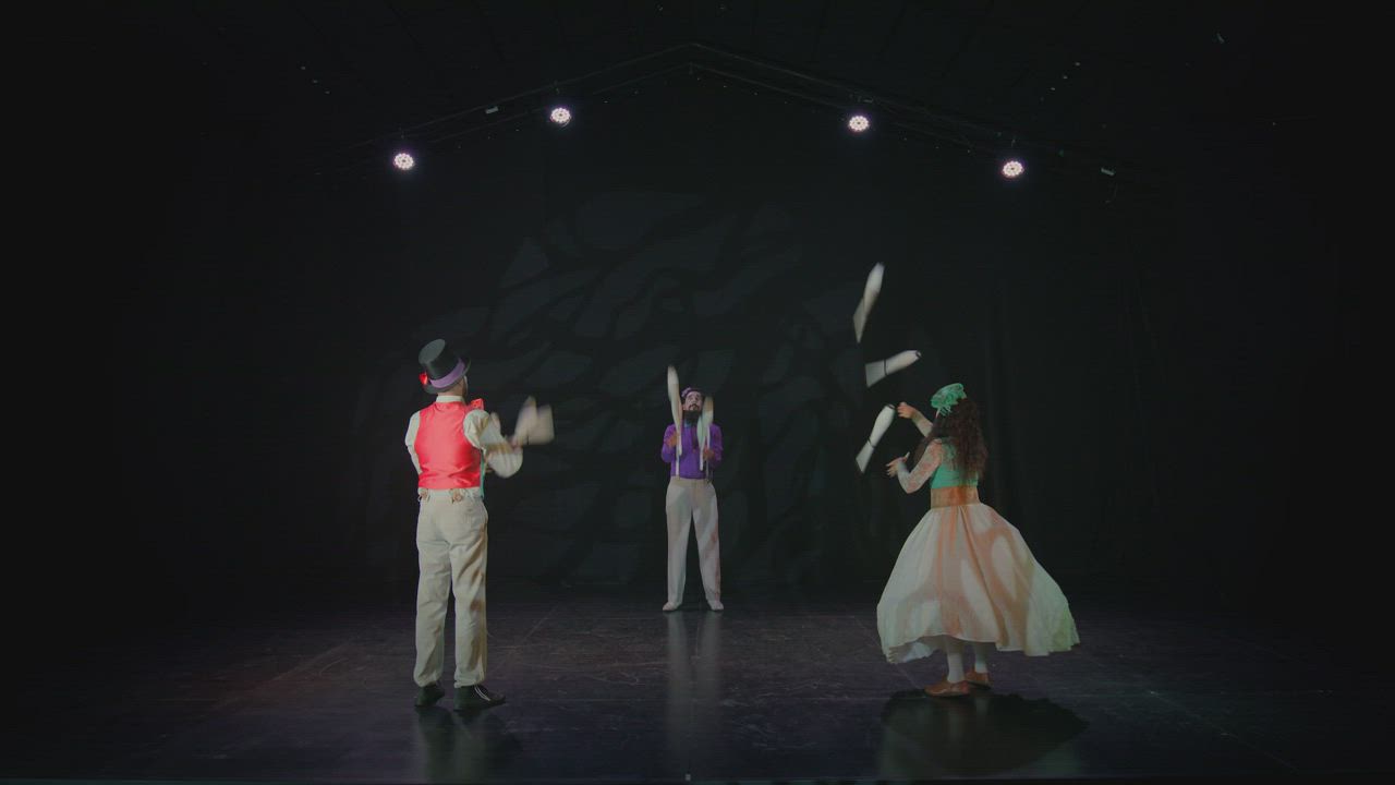 Three people juggling bowling pins together - Free Stock Video