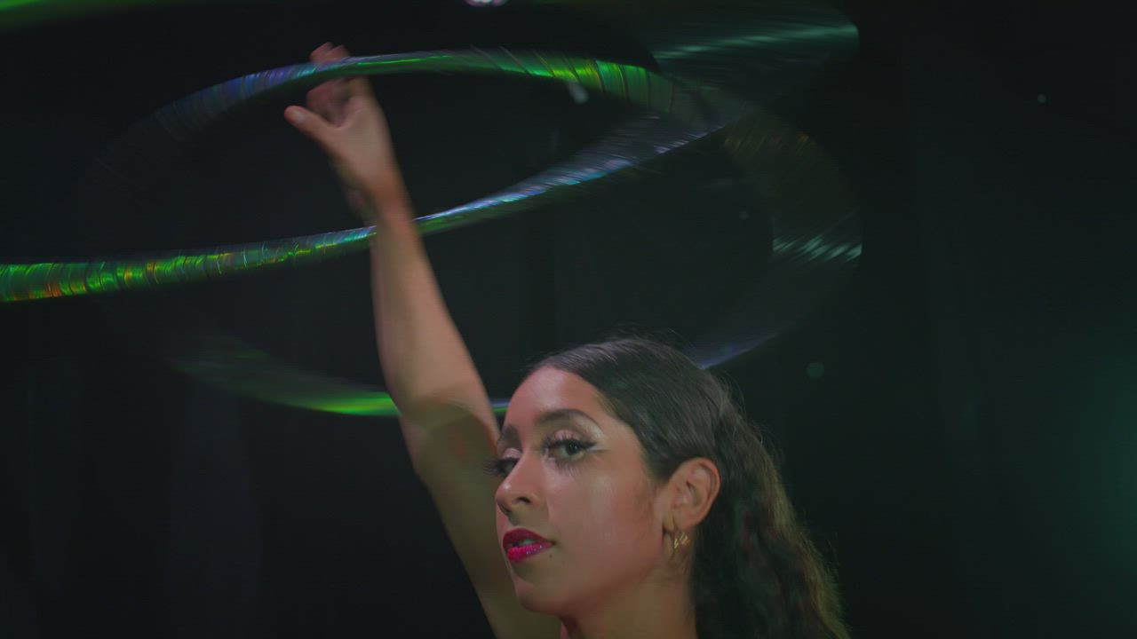 Close shot of a woman spinning many hula hoops - Free Stock Video