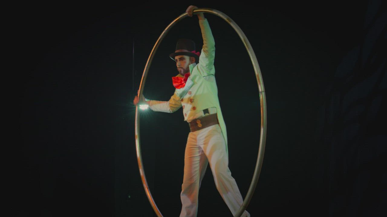 Talented acrobat spinning inside a hoop - Free Stock Video