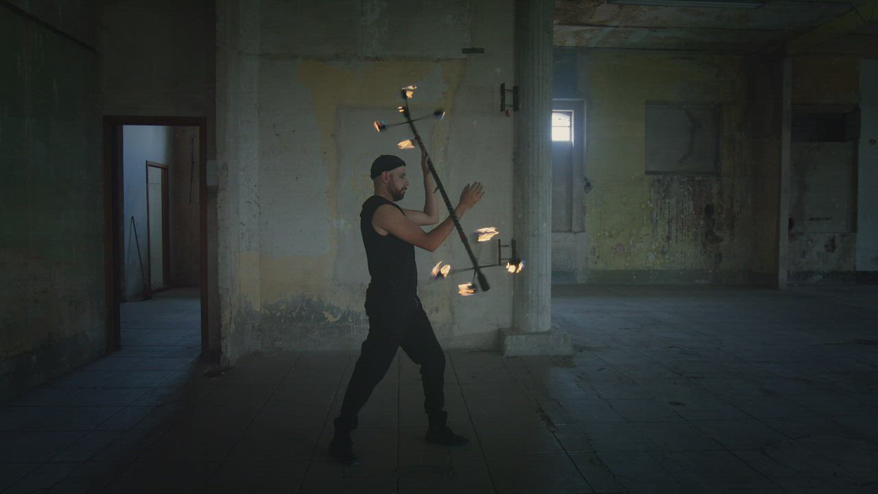 Skillful juggler doing tricks with a stick with fire - Free Stock Video