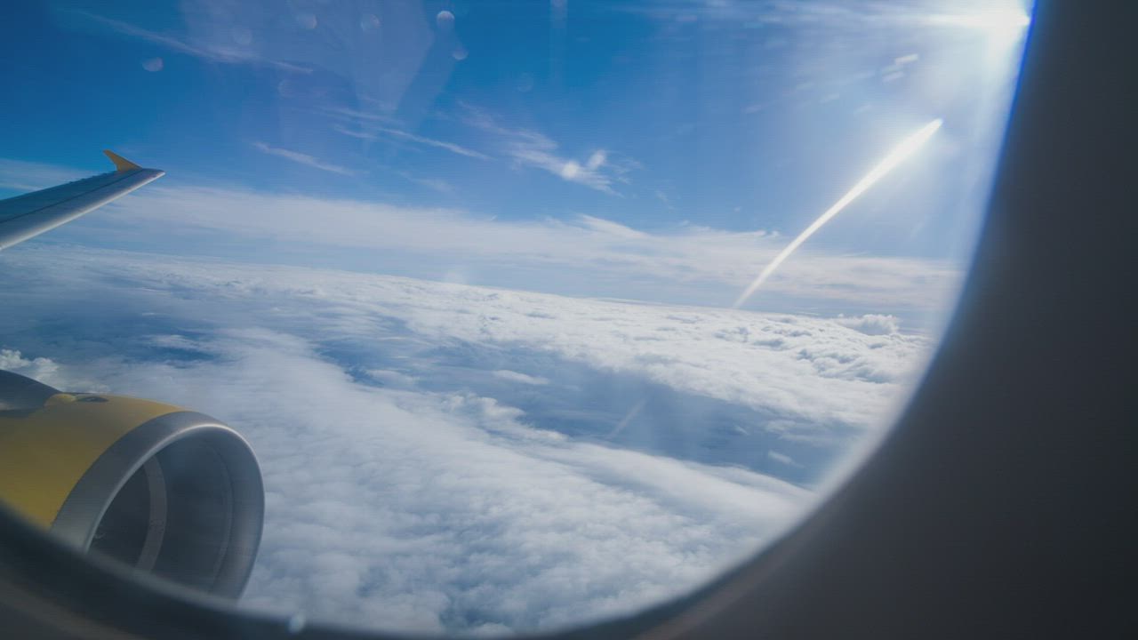 Sky through a plane window - Free Stock Video