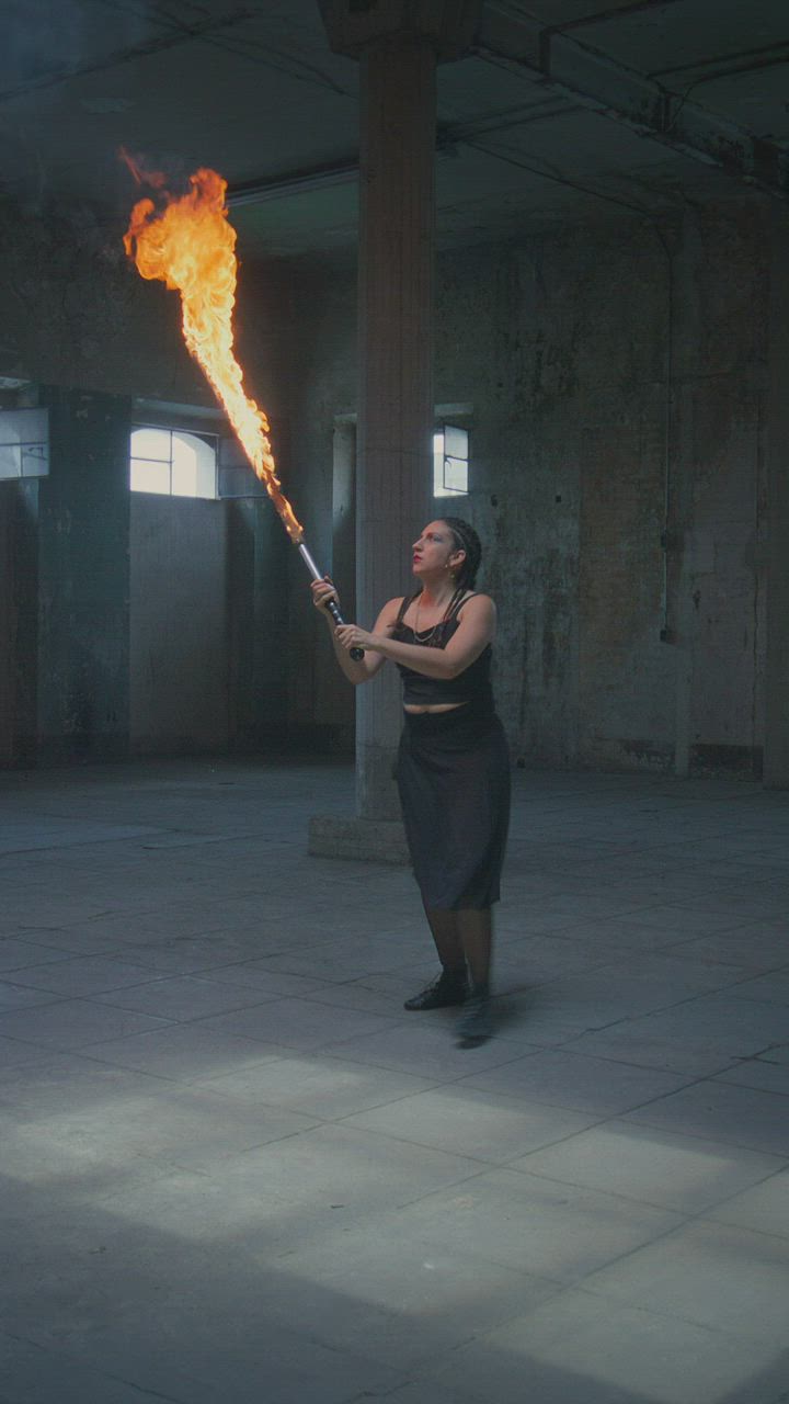 Woman doing a dance with a stick in fire - Free Stock Video