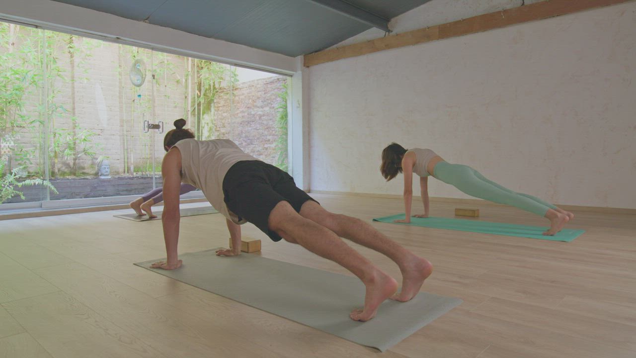Three people doing yoga in a room - Free Stock Video