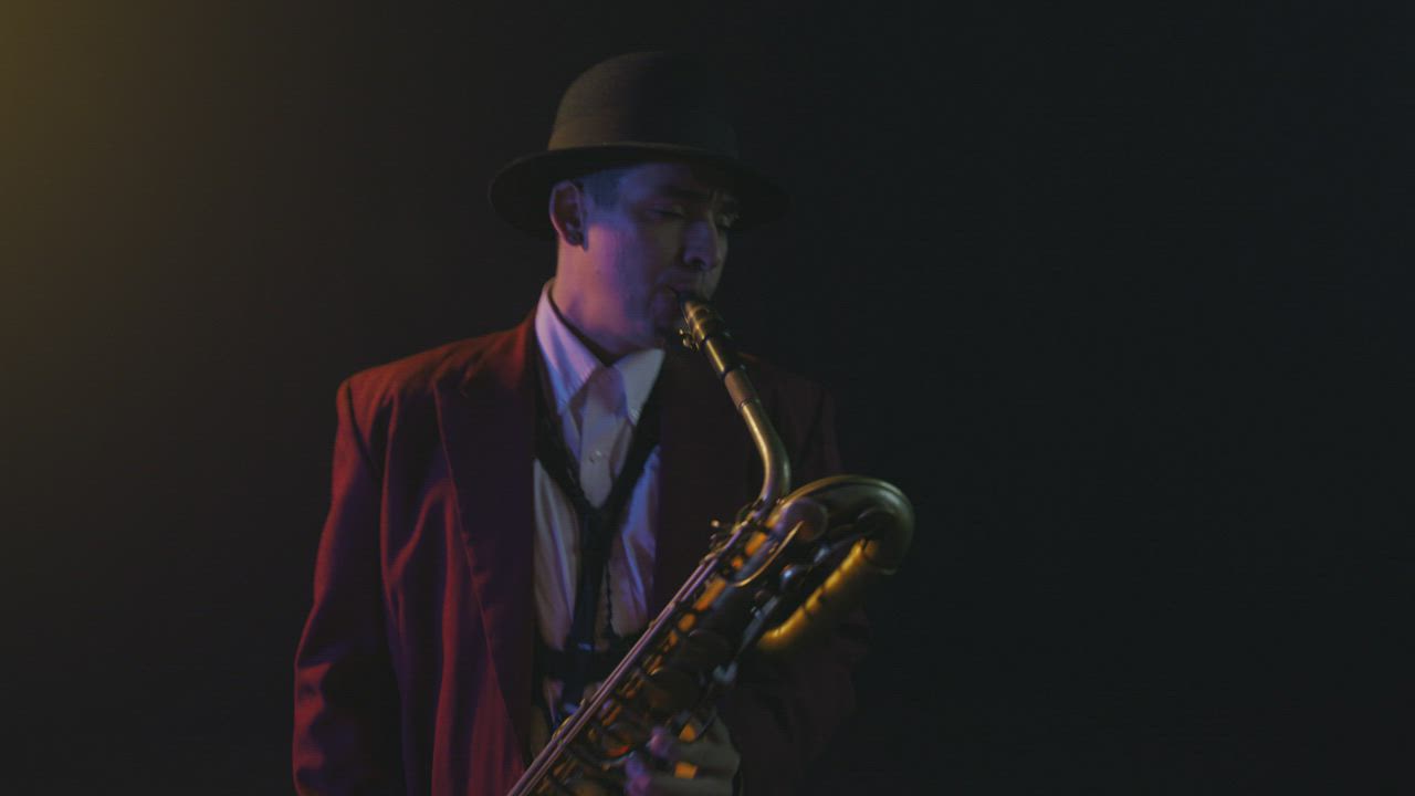 Musician playing the saxophone while dancing - Free Stock Video