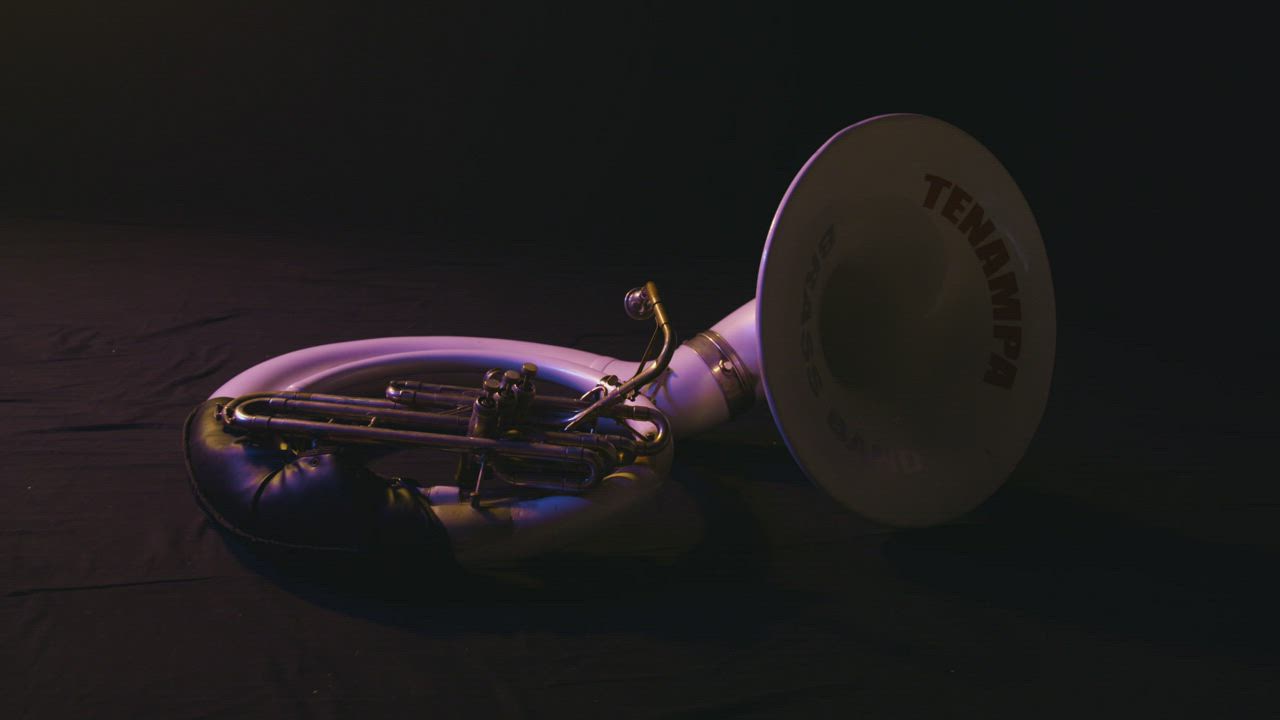 White trombone on a stage floor - Free Stock Video