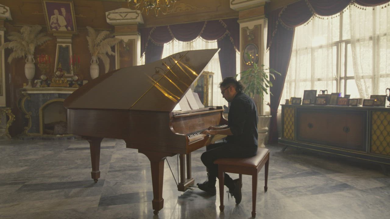 Musician playing on a grand piano in a fancy venue - Free Stock Video