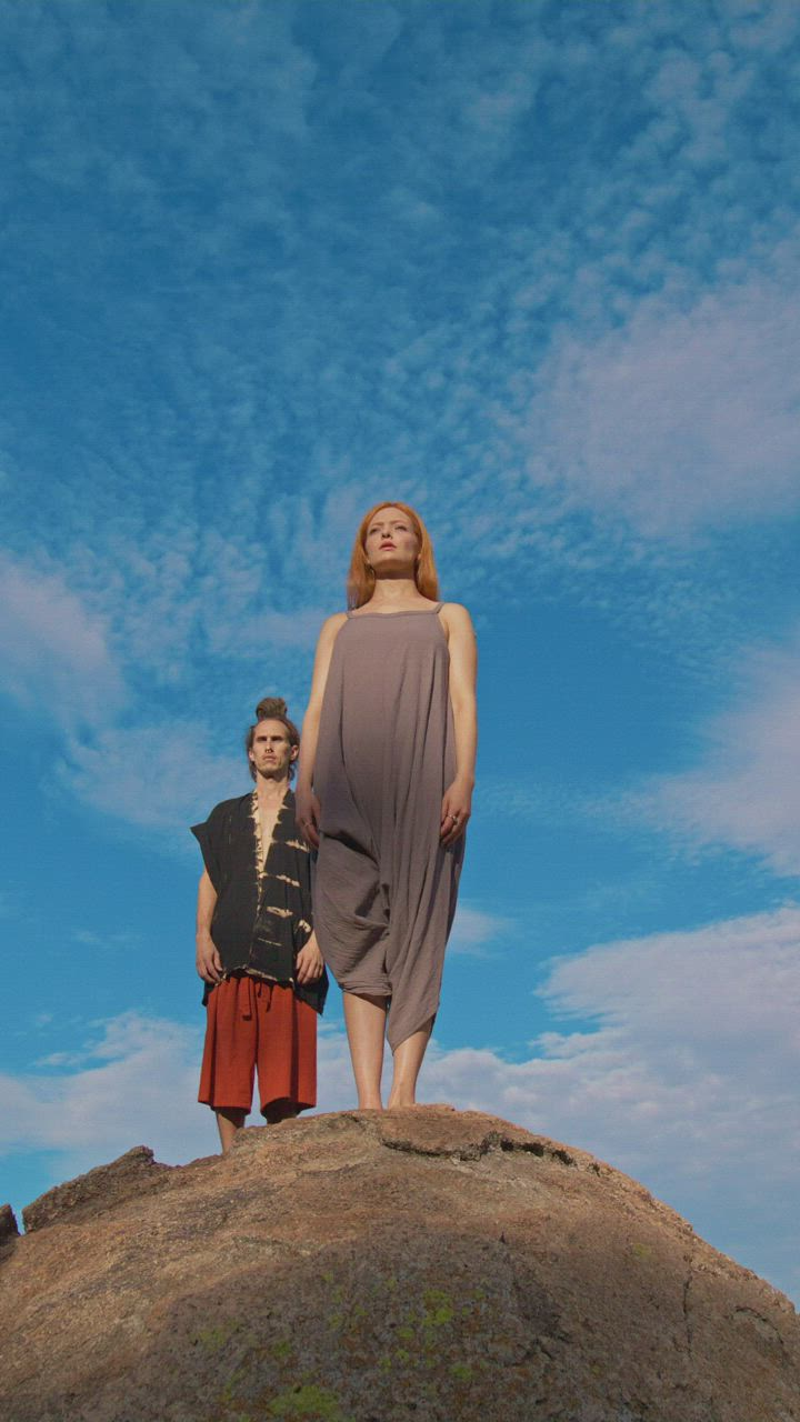 Man and woman doing yoga on top of a rock - Free Stock Video