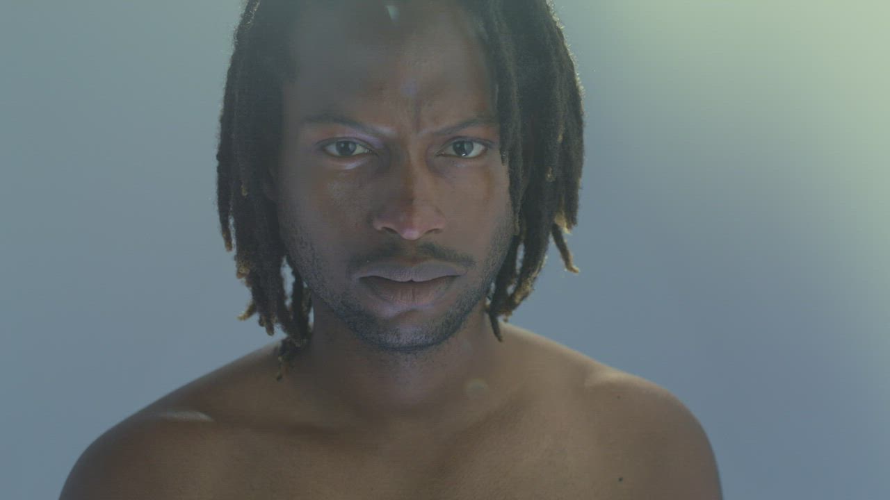 Face of a vulnerable man on a light background - Free Stock Video