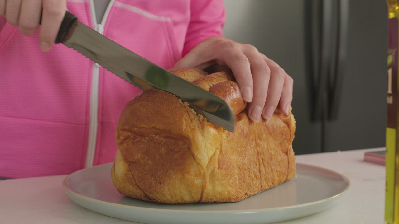 Woman cutting slices of sliced bread - Free Stock Video