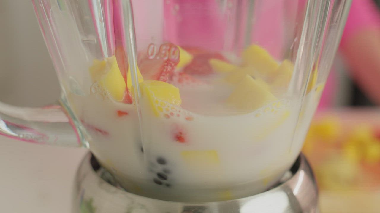 Blending a fruit smoothie in a blender - Free Stock Video