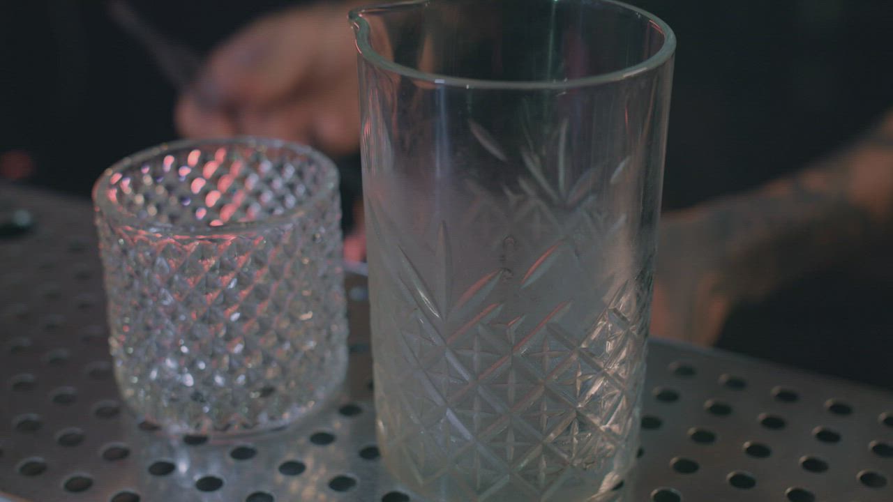 Putting ice in a glass for a drink in a bar - Free Stock Video