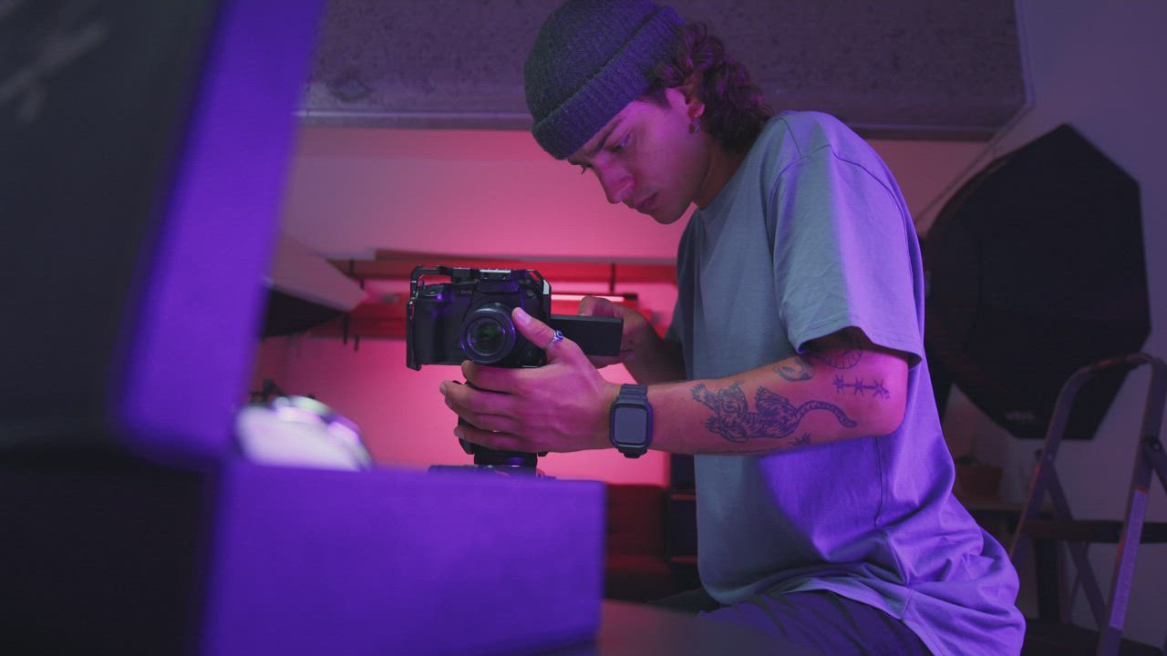 Young man recording with a camera on a set - Free Stock Video